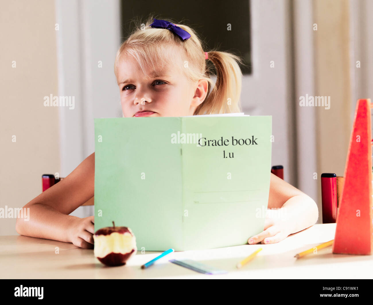 Bored girl doing homework at desk Stock Photo - Alamy