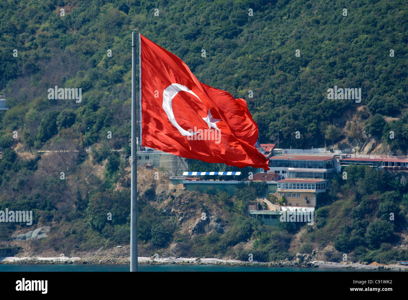 The red Turkish flag with star and crescent flying from the ruins of ...