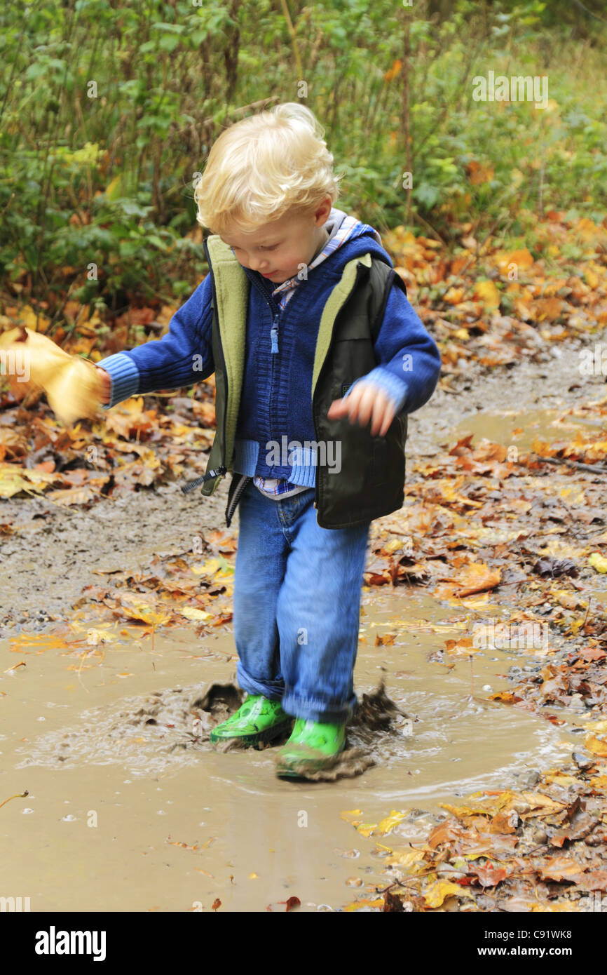 Kid jumping in a mud puddle hi-res stock photography and images - Alamy