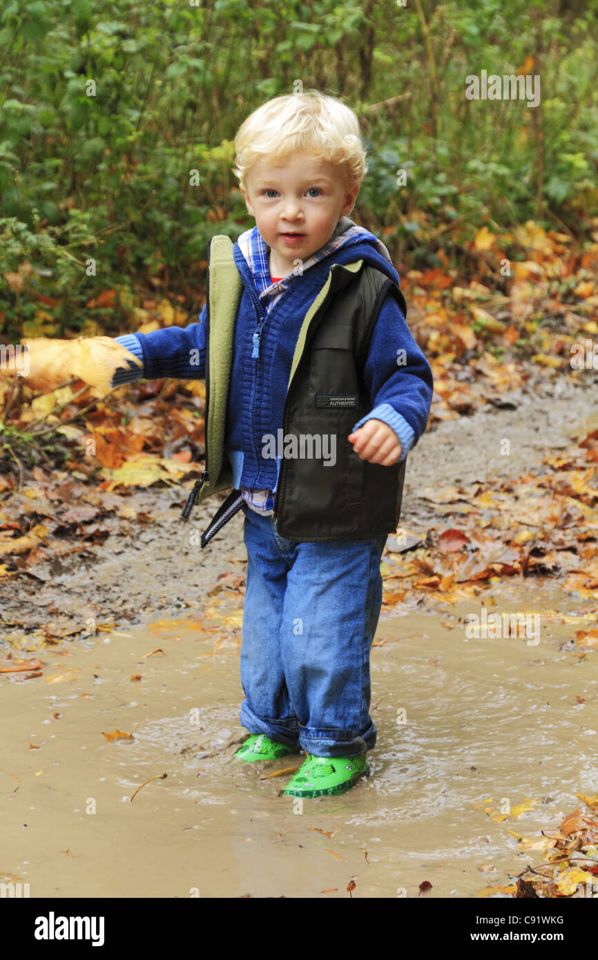 Kid jumping in a mud puddle hi-res stock photography and images - Alamy