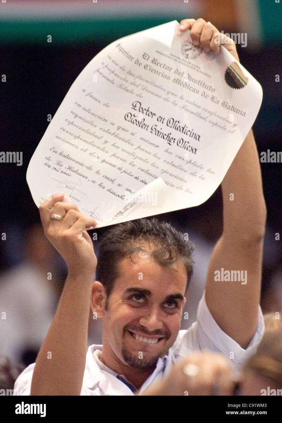Happy young Cuban doctor proudly showing his college degree during a ...