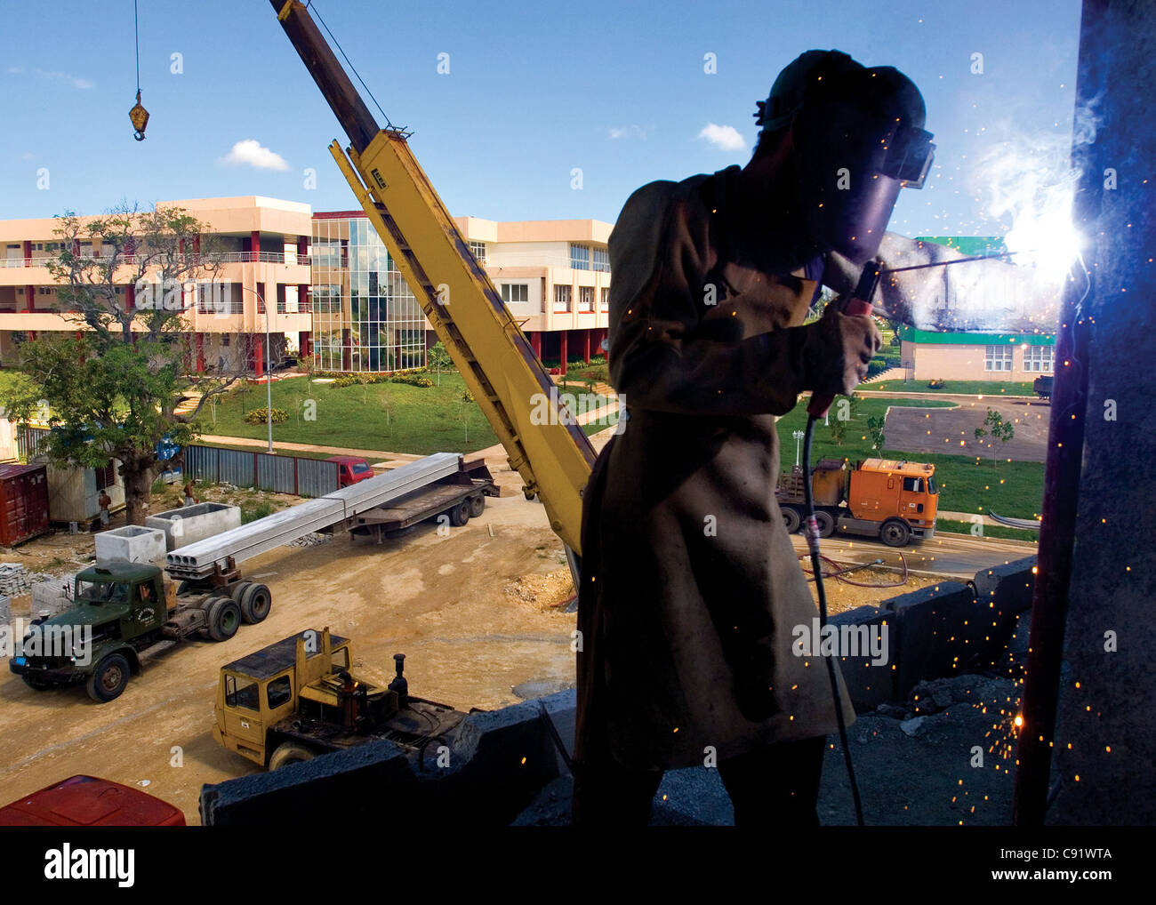 Construction worker working and welding at the modern buildings of UCI ...