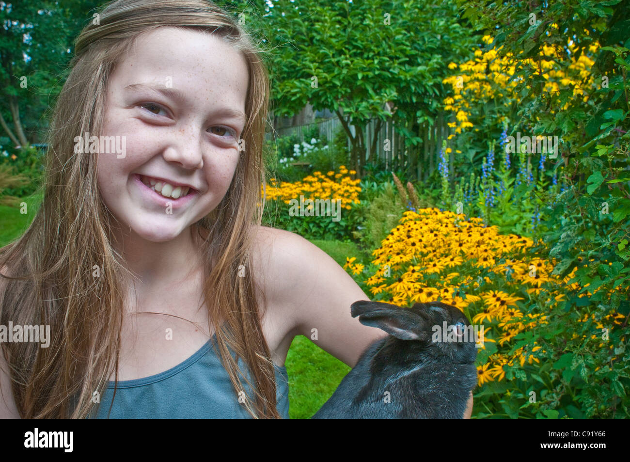 Young teenager w pet rabbit in backyard garden Stock Photo - Alamy