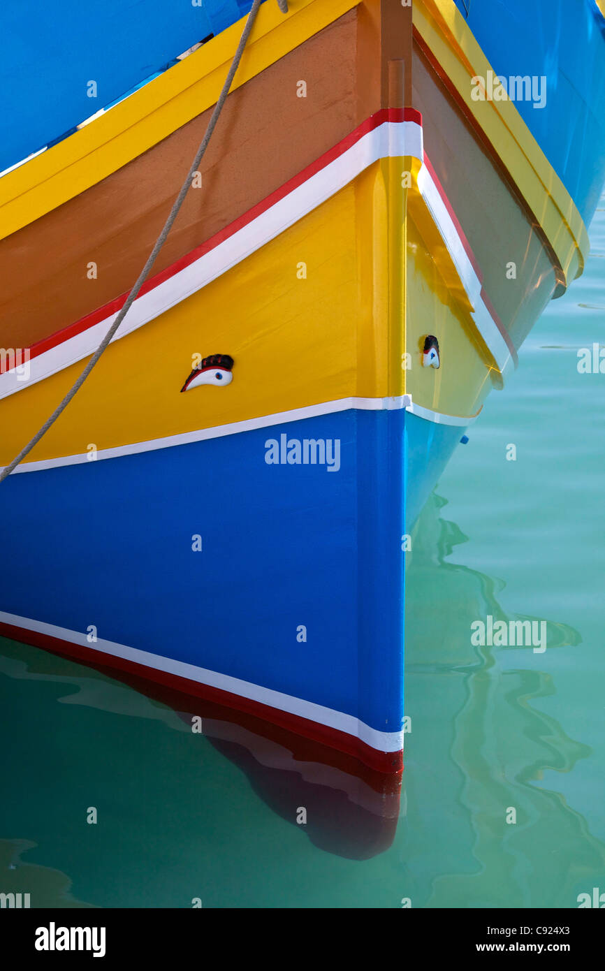 A 'Luzzu' - traditional Maltese fishing boat painted in blue yellow and ...