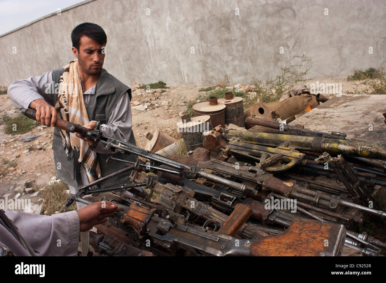 Former militia look at weapons at an army base, as part of a UN DDR ...