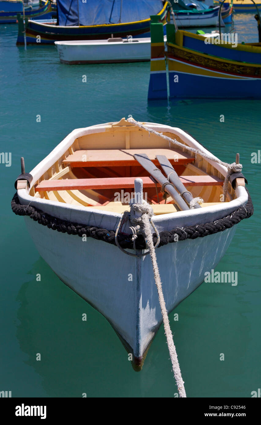 Moored rowing boat in the harbour of Marsaxlokk Stock Photo - Alamy