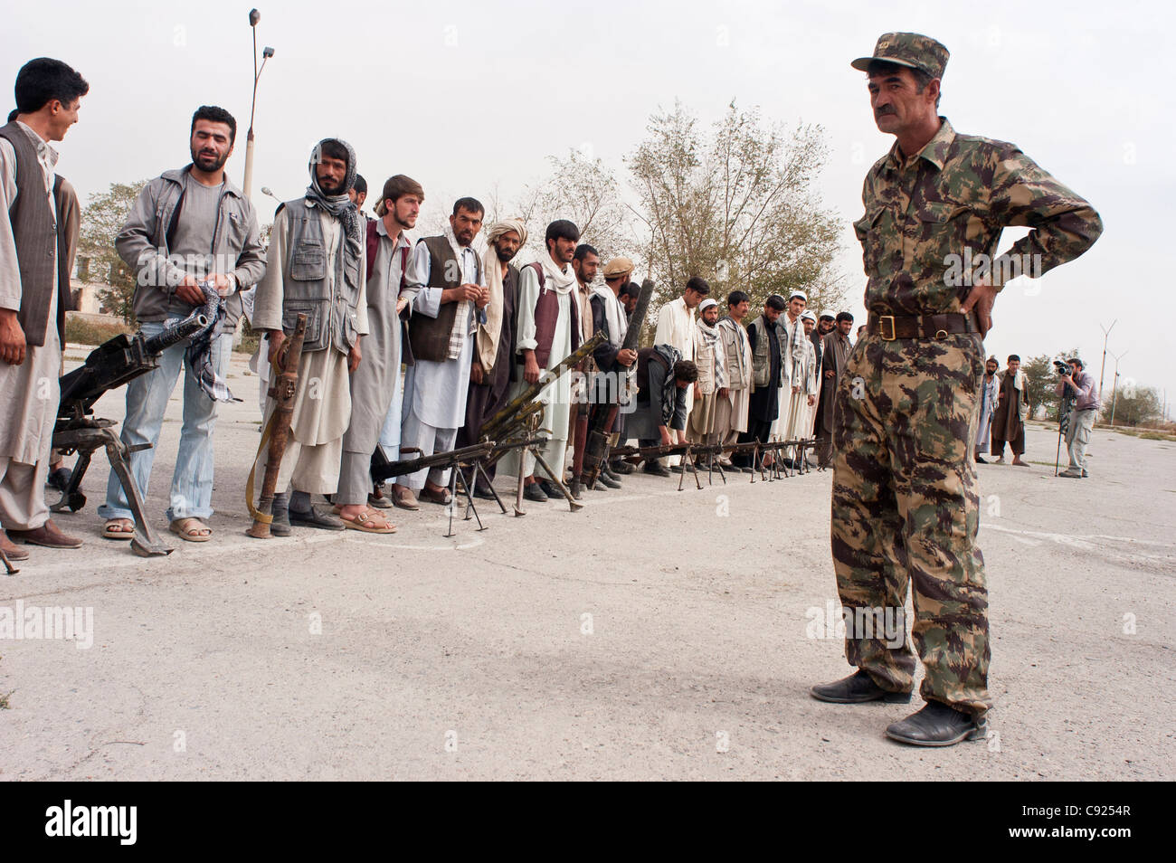 Former militia fighters gather at an army base, as part of a UN DDR ...