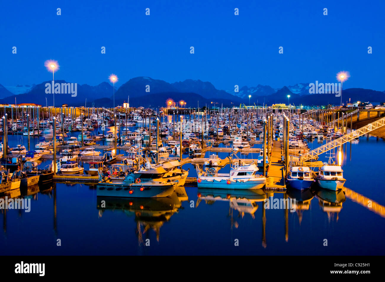 Dusk view of the Homer small boat harbor with Kenai Mountains in the ...