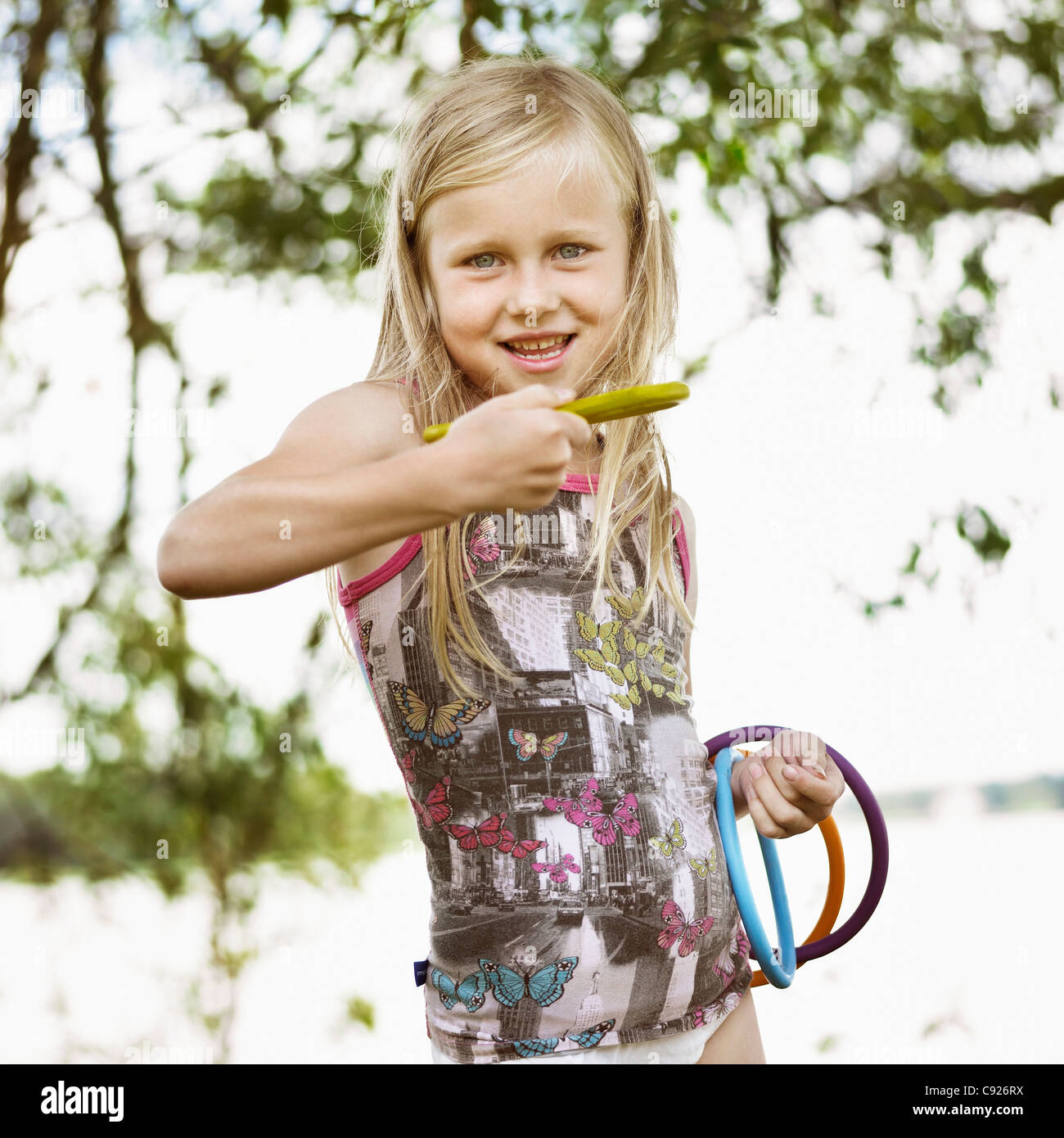 Girl throwing rings outdoors Stock Photo - Alamy