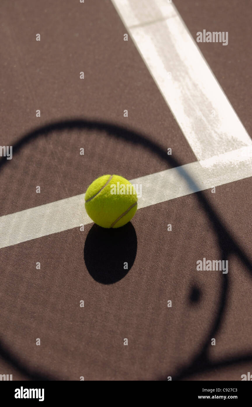 Tennis ball on court, under shadow of tennis racquet Stock Photo - Alamy