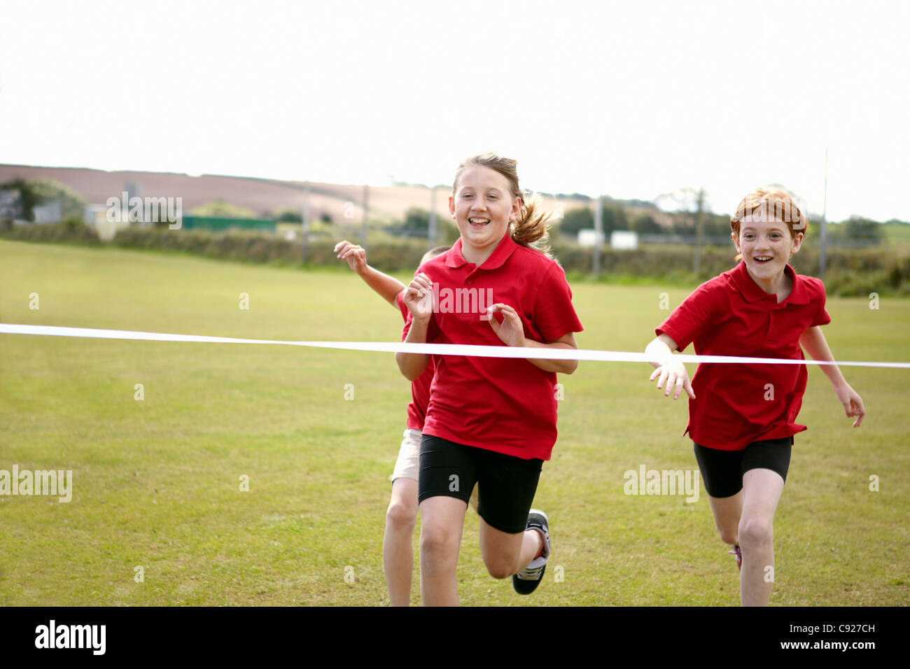 Girls racing to cross finish line Stock Photo - Alamy