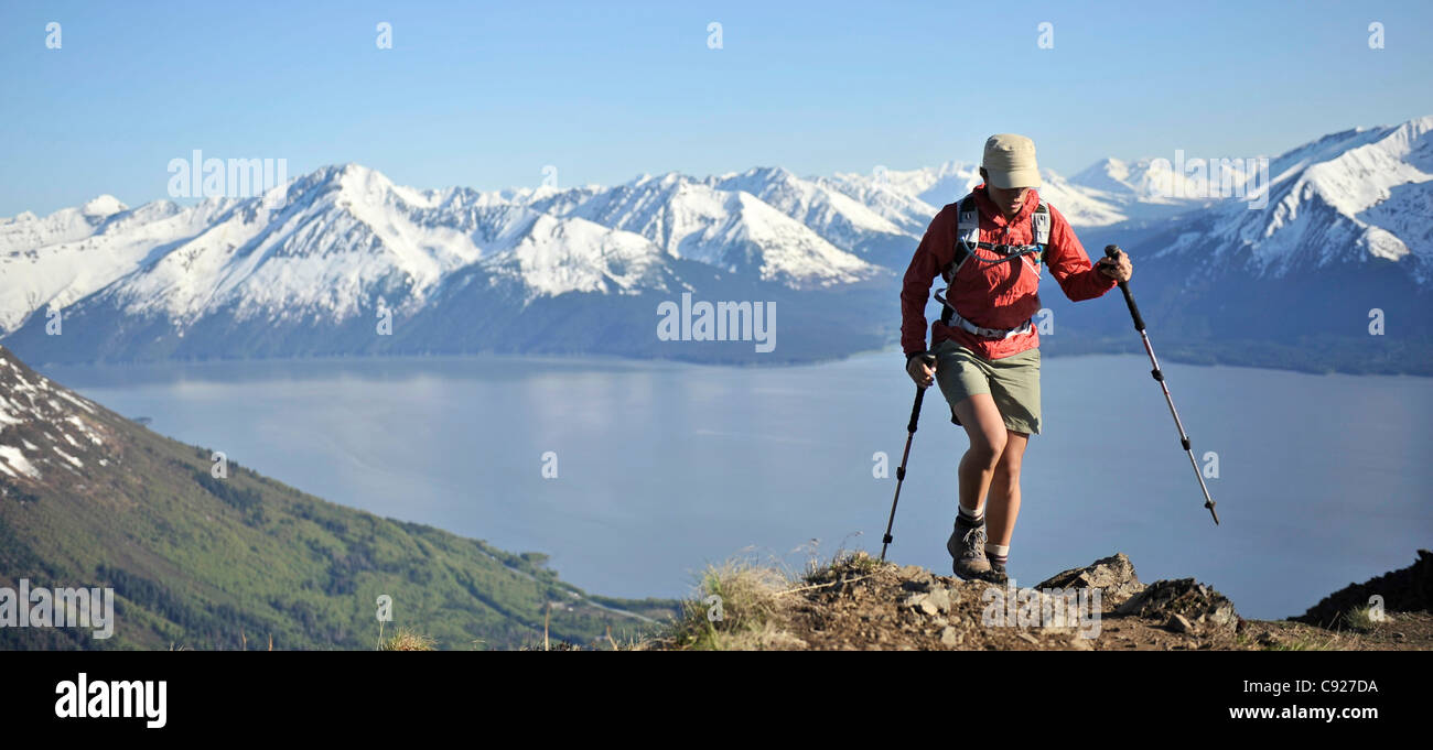 Woman hikes up the Bird Ridge Trail in Chugach State Park with the ...