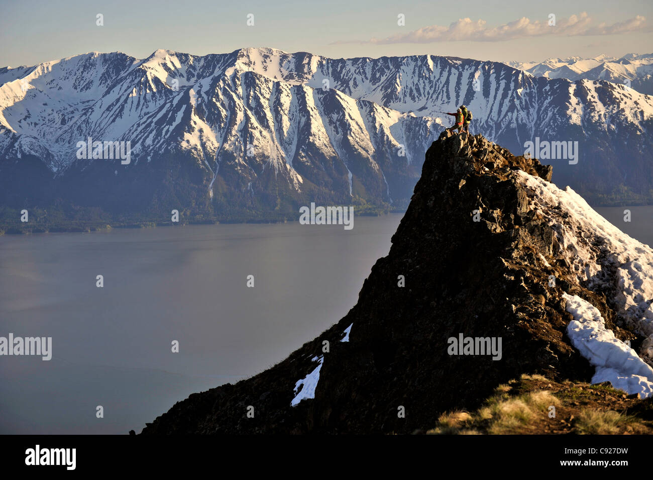 Couple stand on the summit of Bird Ridge in Chugach State Park with the ...