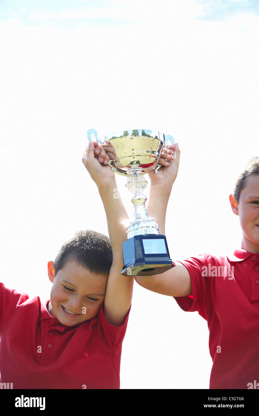Boys cheering with trophy outdoors Stock Photo - Alamy