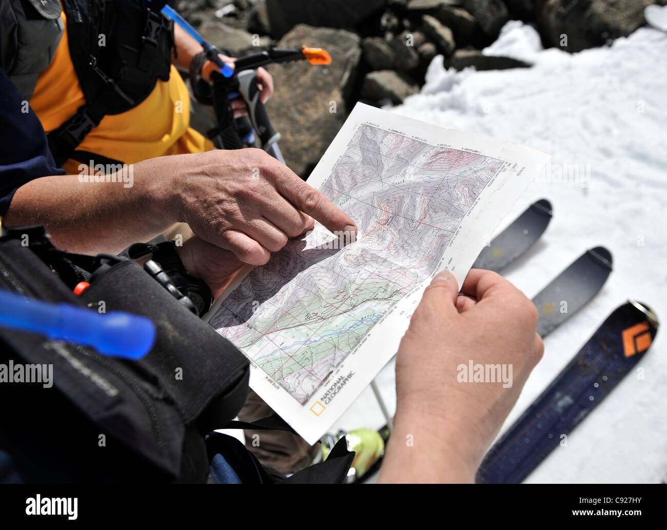 Two backcountry skiers review a map to navigate up Water Fall Creek ...