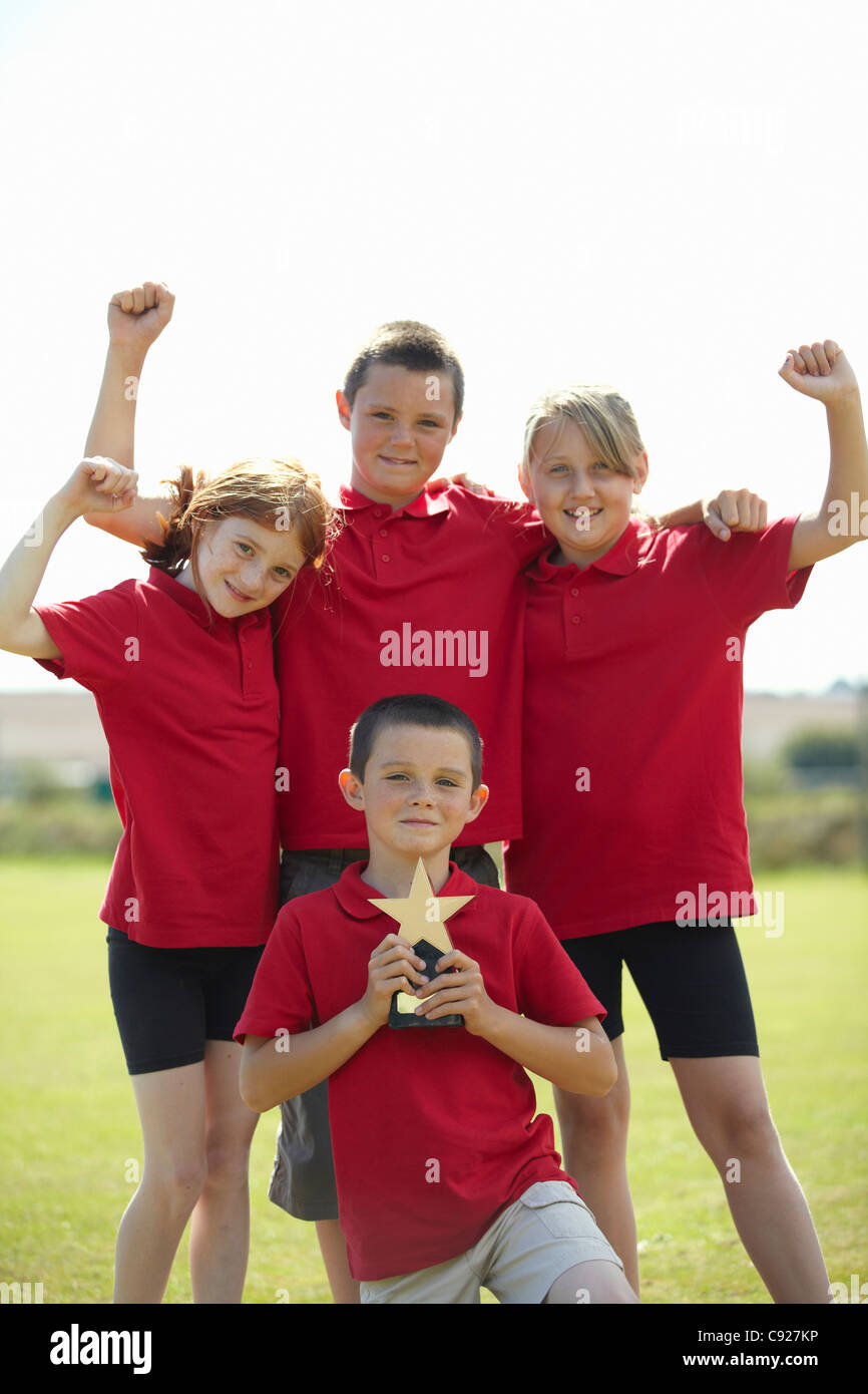 Children cheering with trophy outdoors Stock Photo - Alamy