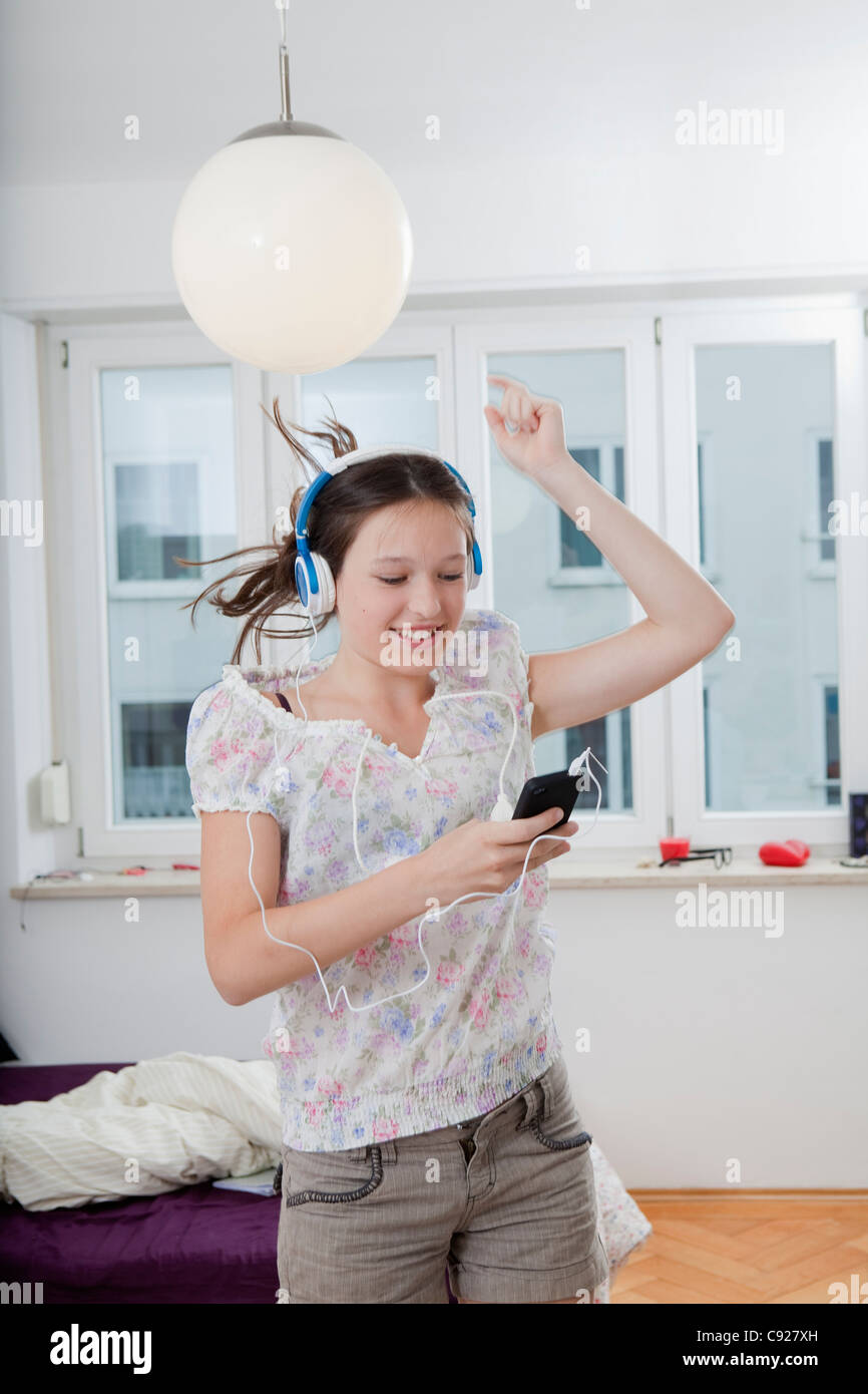 Girl dancing to mp3 player Stock Photo - Alamy