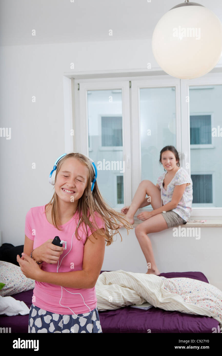 Smiling girl dancing to mp3 player Stock Photo - Alamy