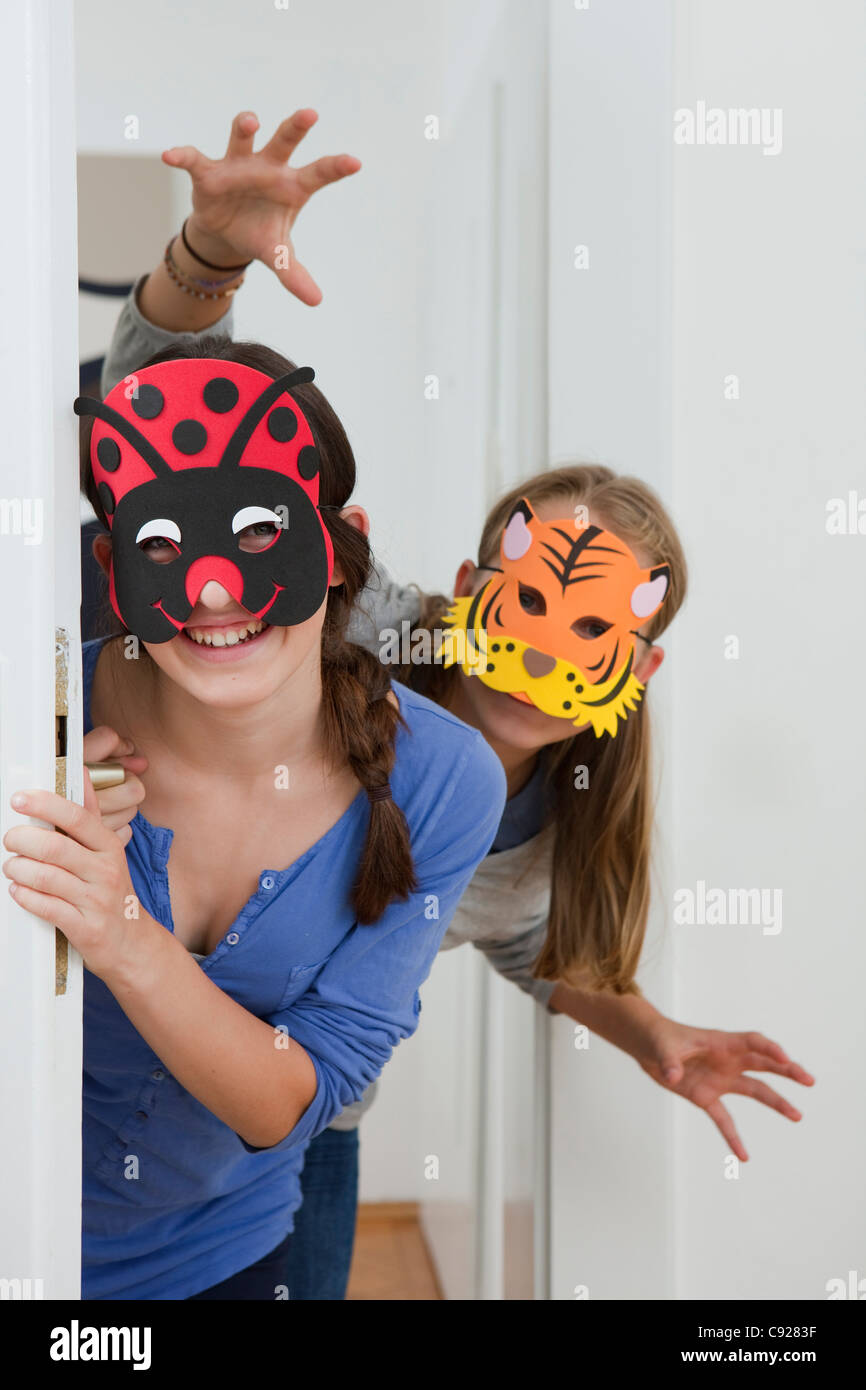 Smiling girls wearing colorful masks Stock Photo - Alamy