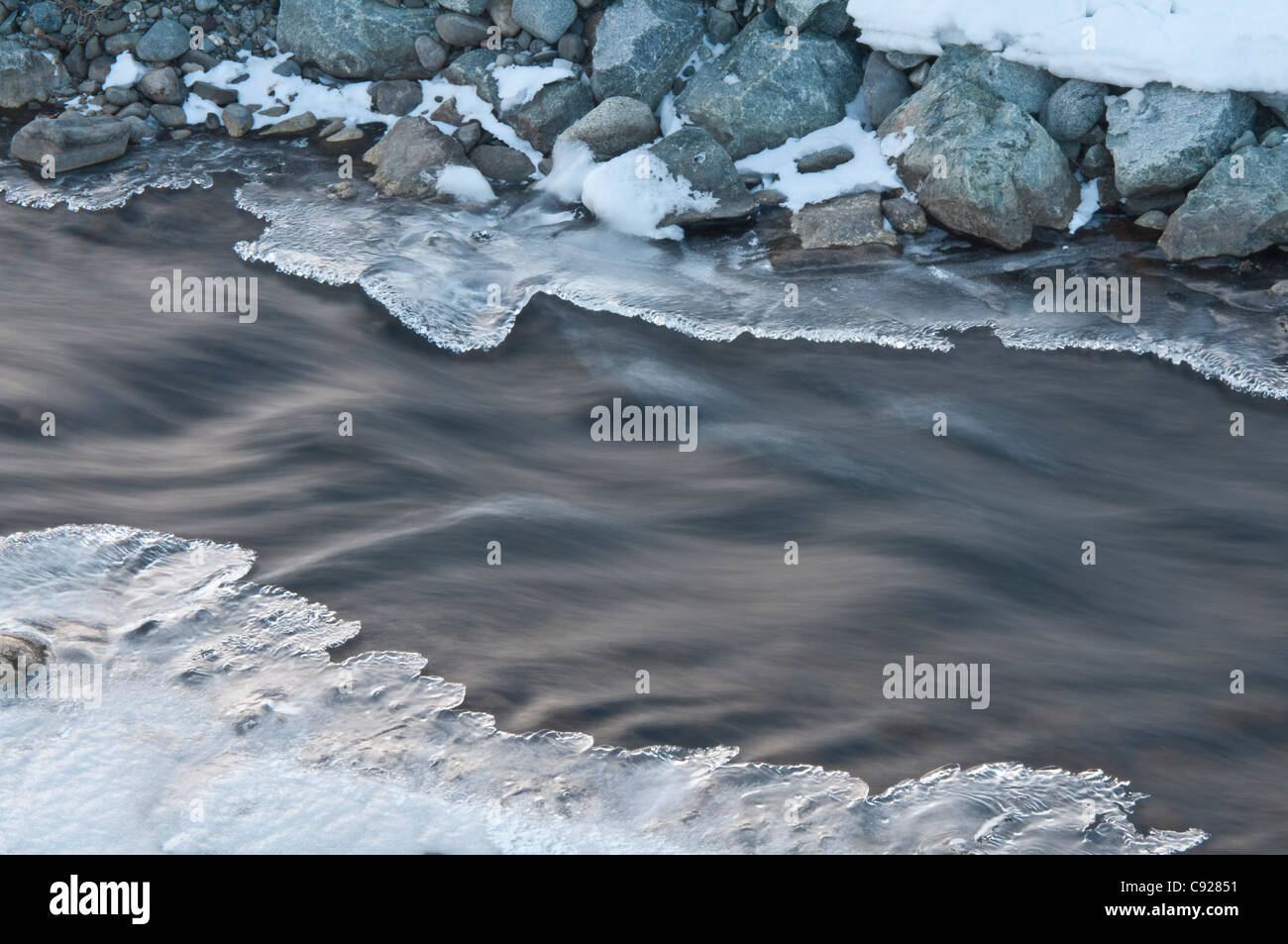 Ice lines the stream flowing from Westchester Lagoon into Cook Inlet ...