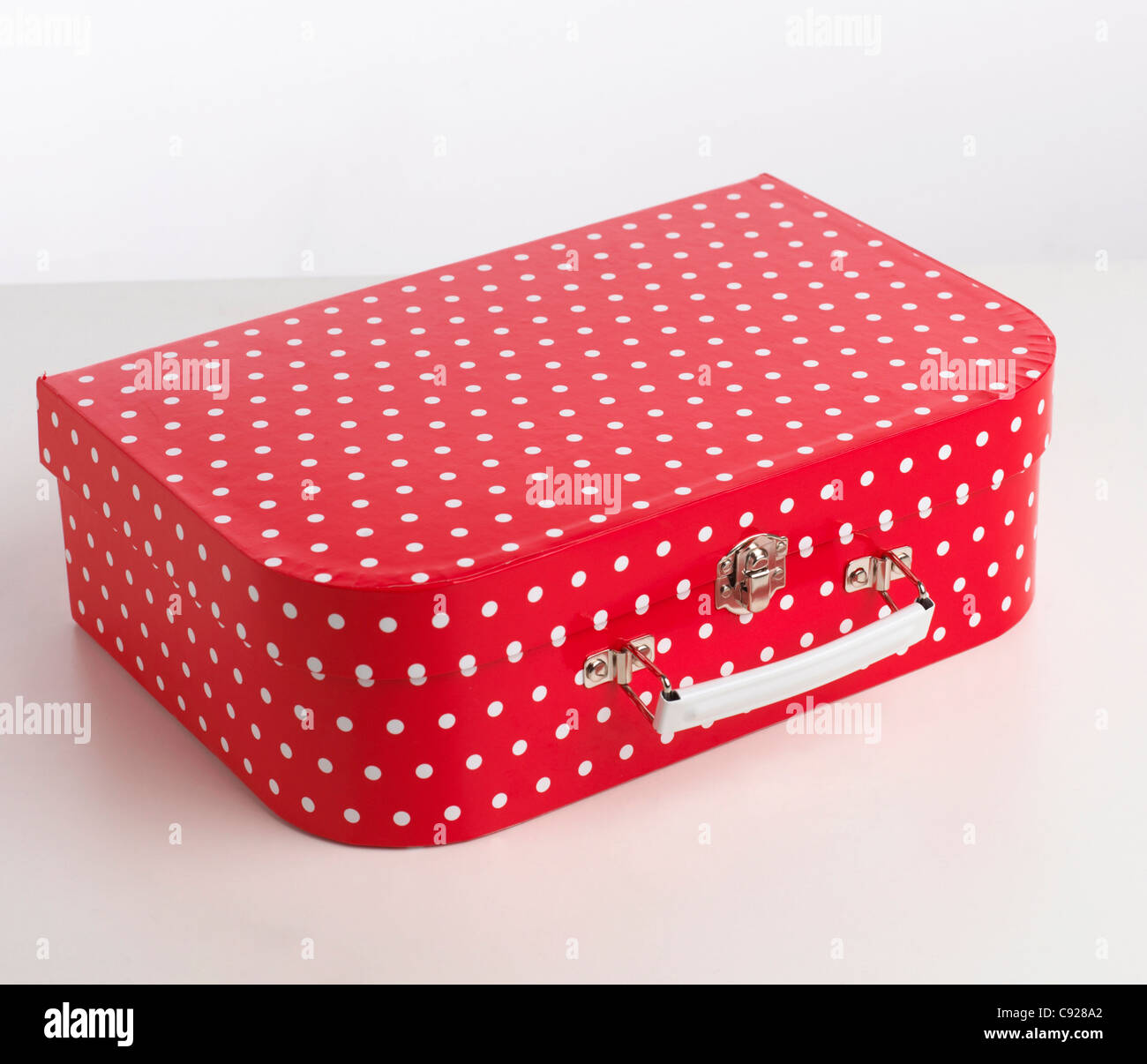 Red suitcase with white spots Stock Photo - Alamy