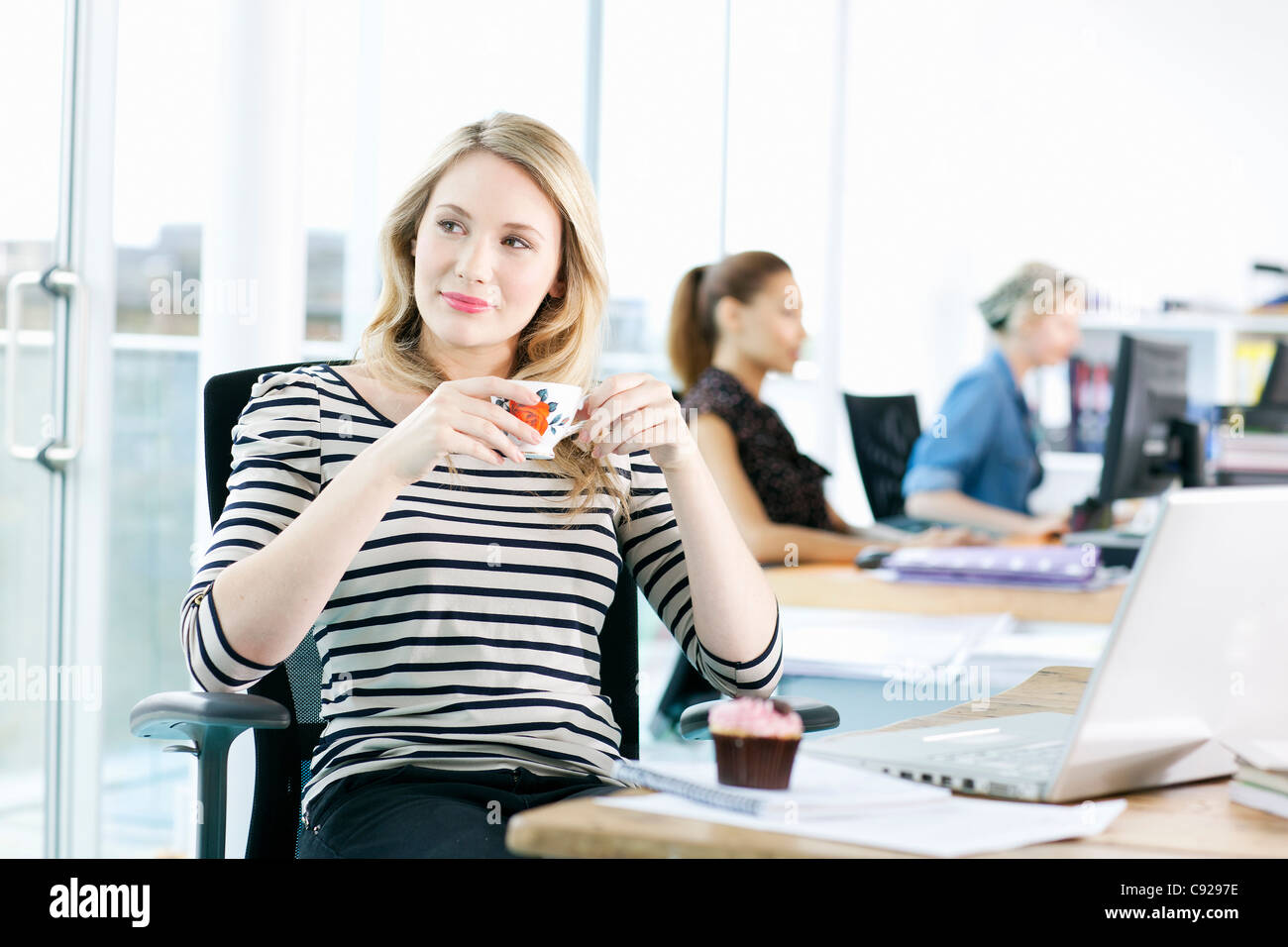 Woman Snacking At Her Desk High Resolution Stock Photography and Images ...