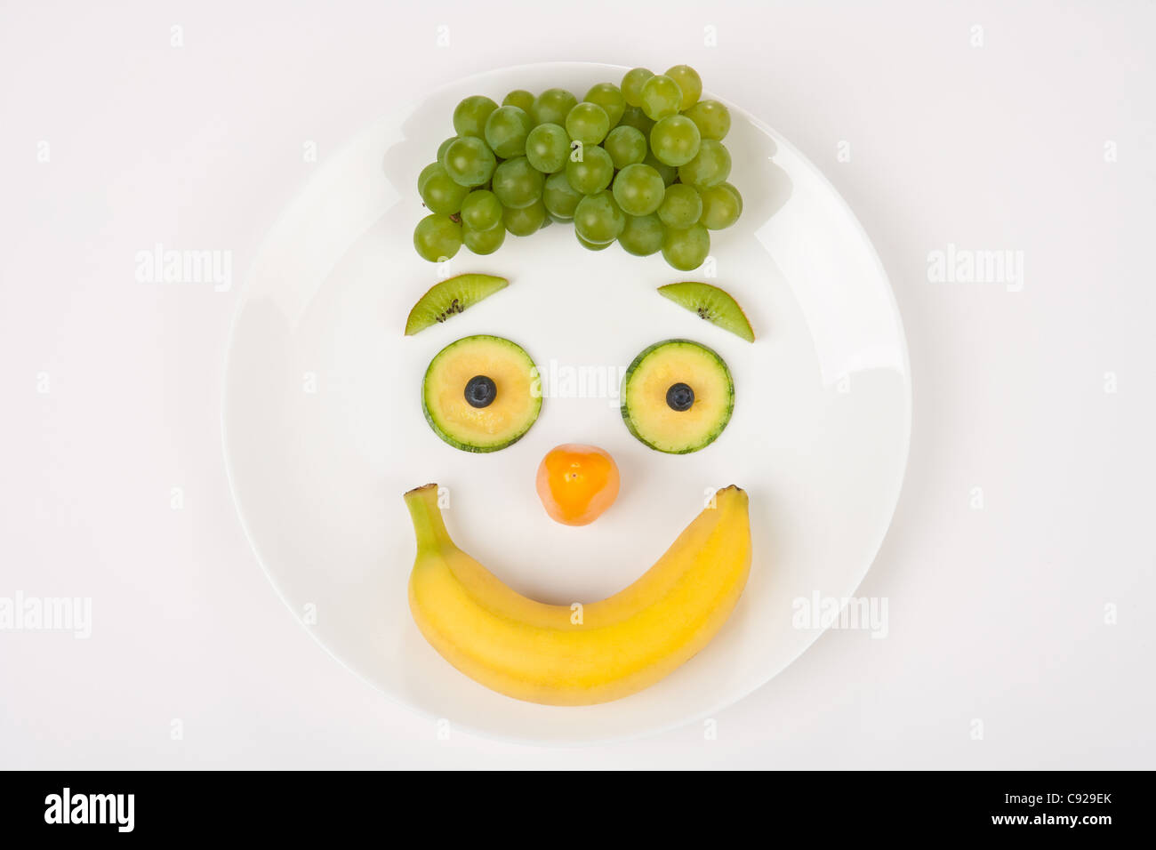 High angle view of human face shape made from vegetables and fruits ...