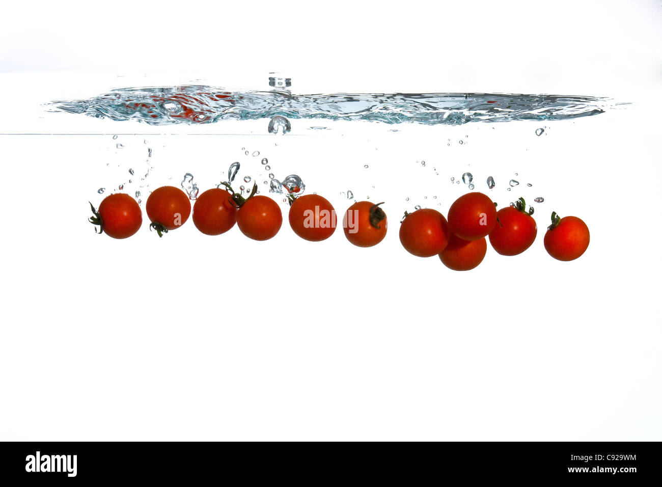 Tomatoes splashing in water Stock Photo - Alamy