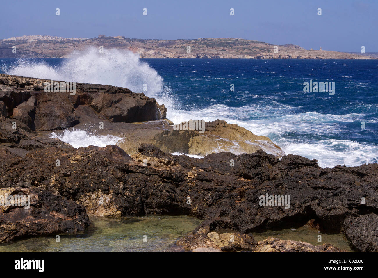 Waves crash over Qawra Point next to Ta' Fra Ben bay Stock Photo - Alamy