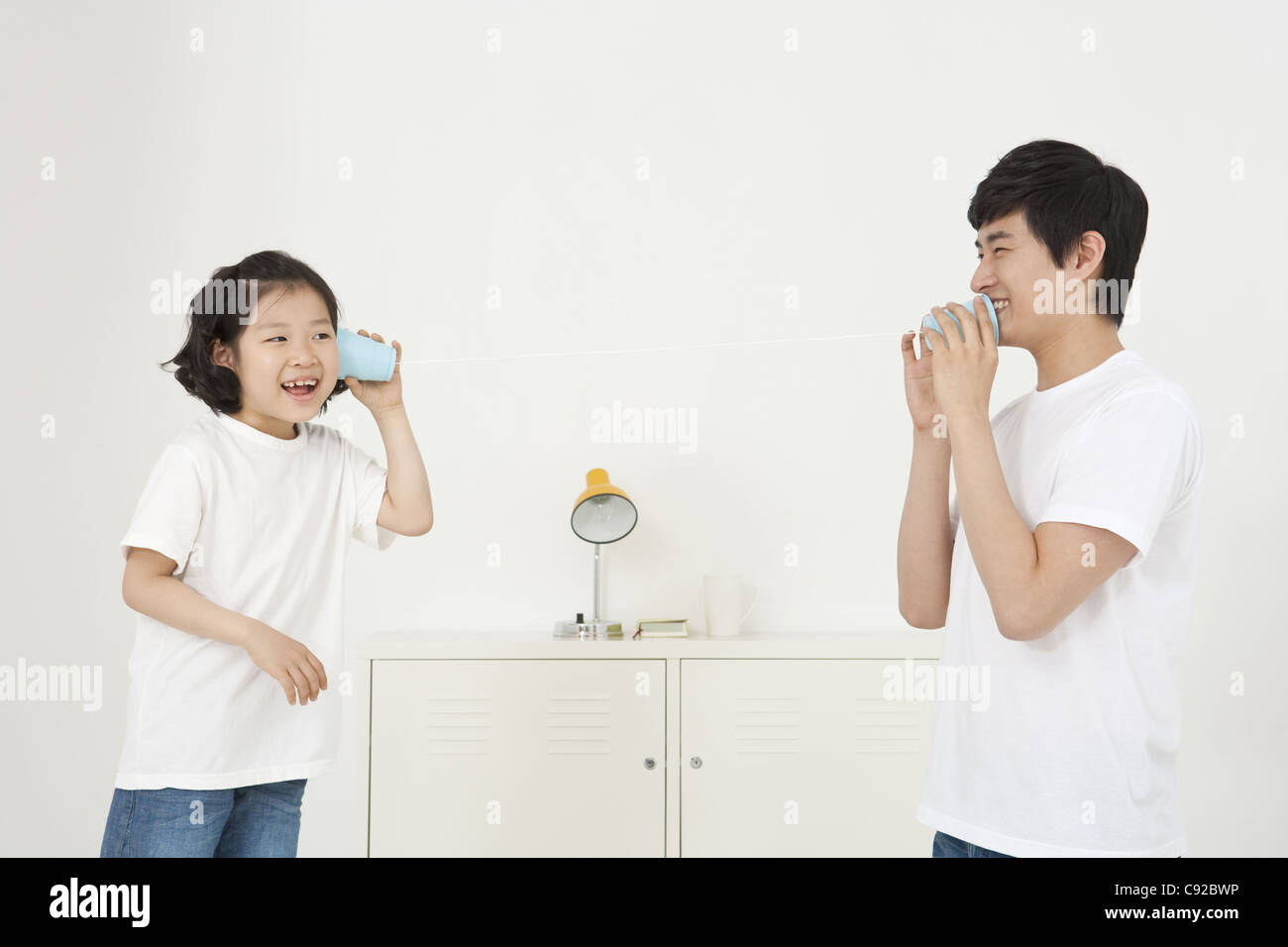 Man girl people objects cup string hi-res stock photography and images ...