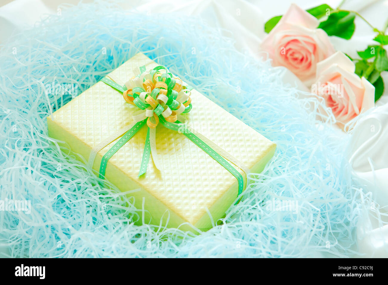 Present box wrapped with green ribbon Stock Photo - Alamy