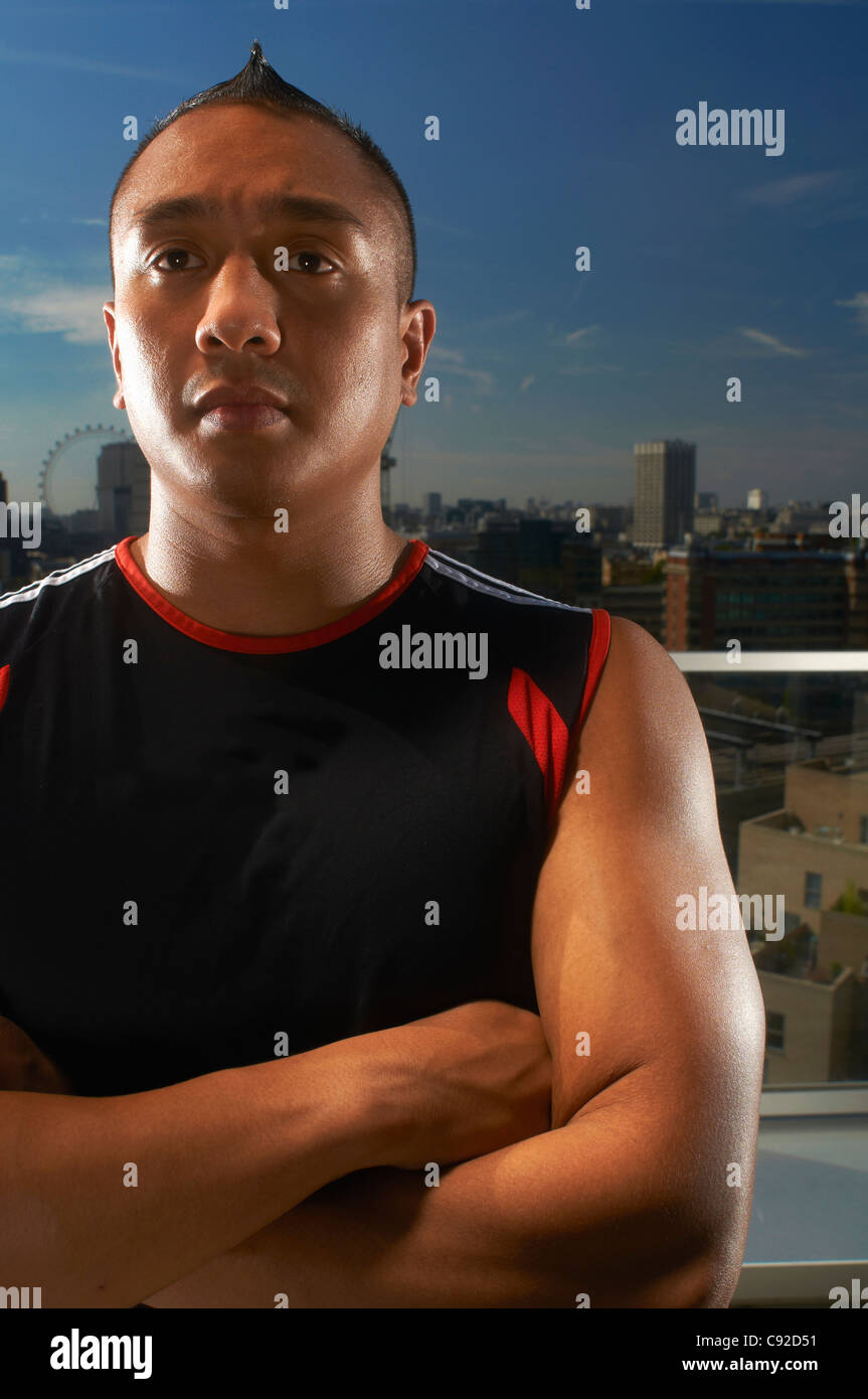 Man standing on urban rooftop Stock Photo - Alamy