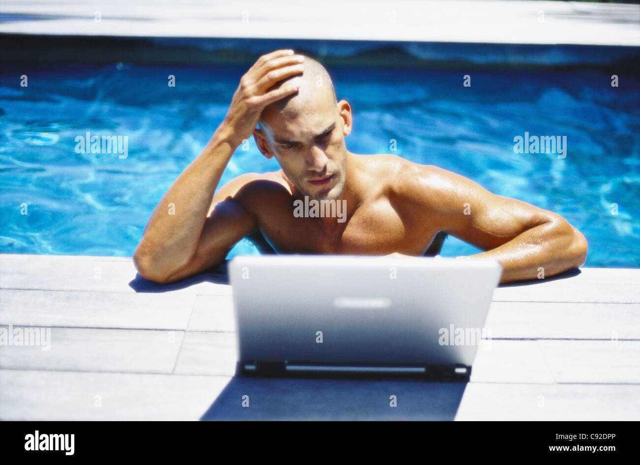 Man using laptop in swimming pool Stock Photo - Alamy