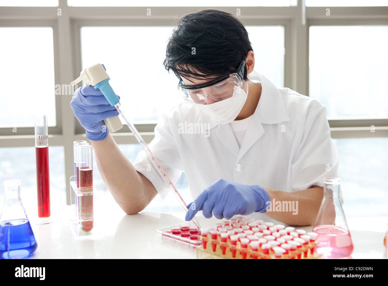 Man glasses pipette biochemistry mask hi-res stock photography and ...