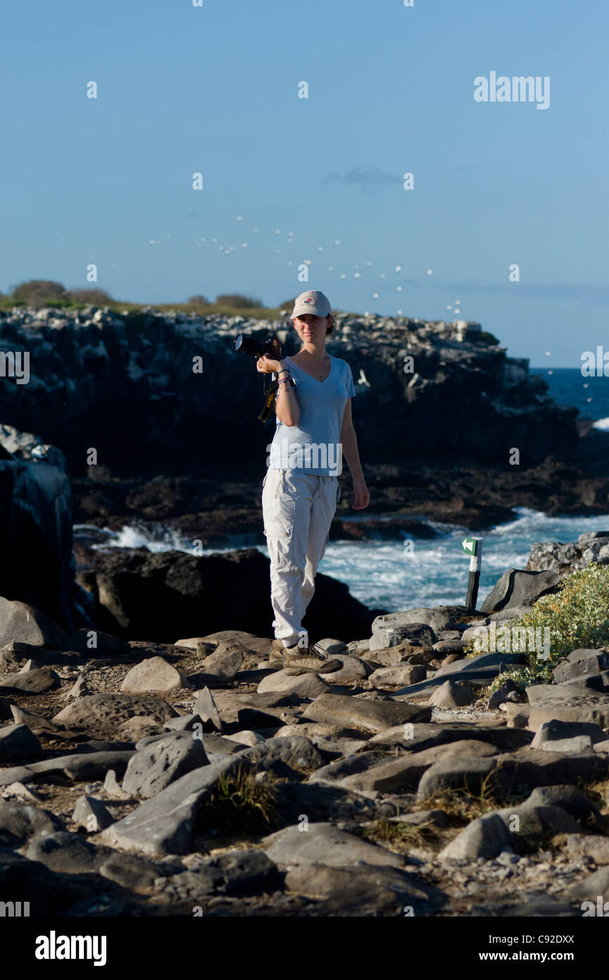Woman standing on the coast, Punta Suarez, Espanola Island, Galapagos ...