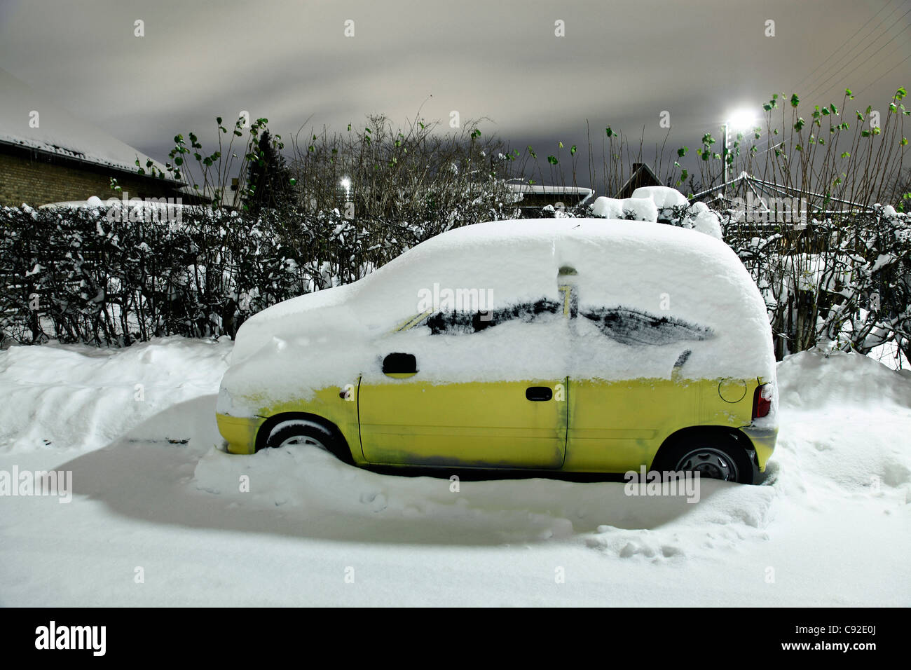 Snow covered car in driveway Stock Photo - Alamy