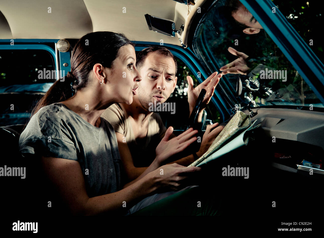 Arguing couple driving while lost Stock Photo - Alamy