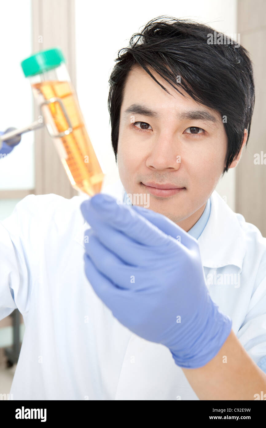 Scientist holding test tube Stock Photo - Alamy