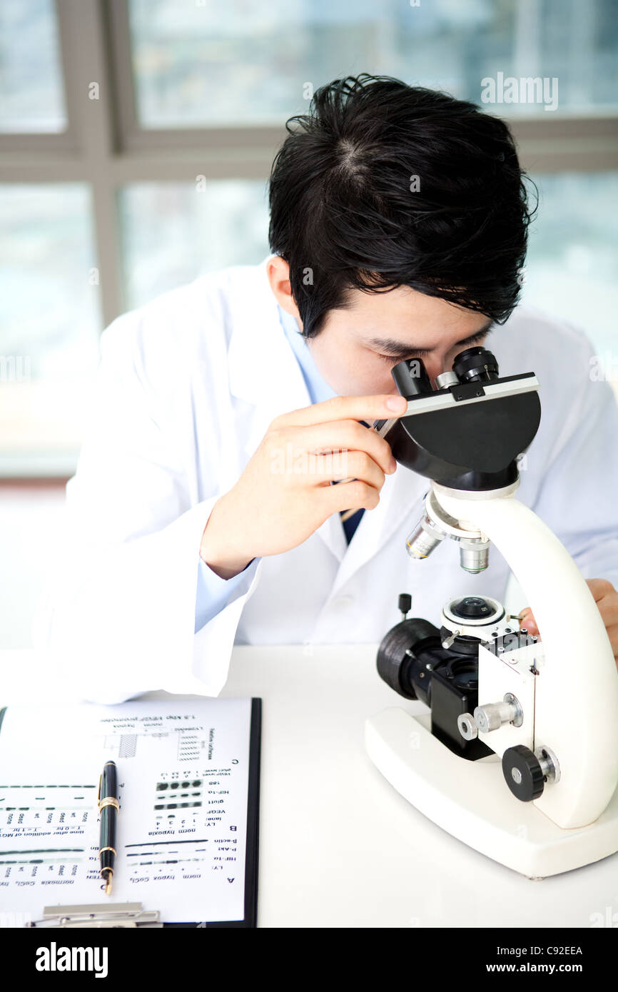 Young asian scientist looking through hi-res stock photography and ...