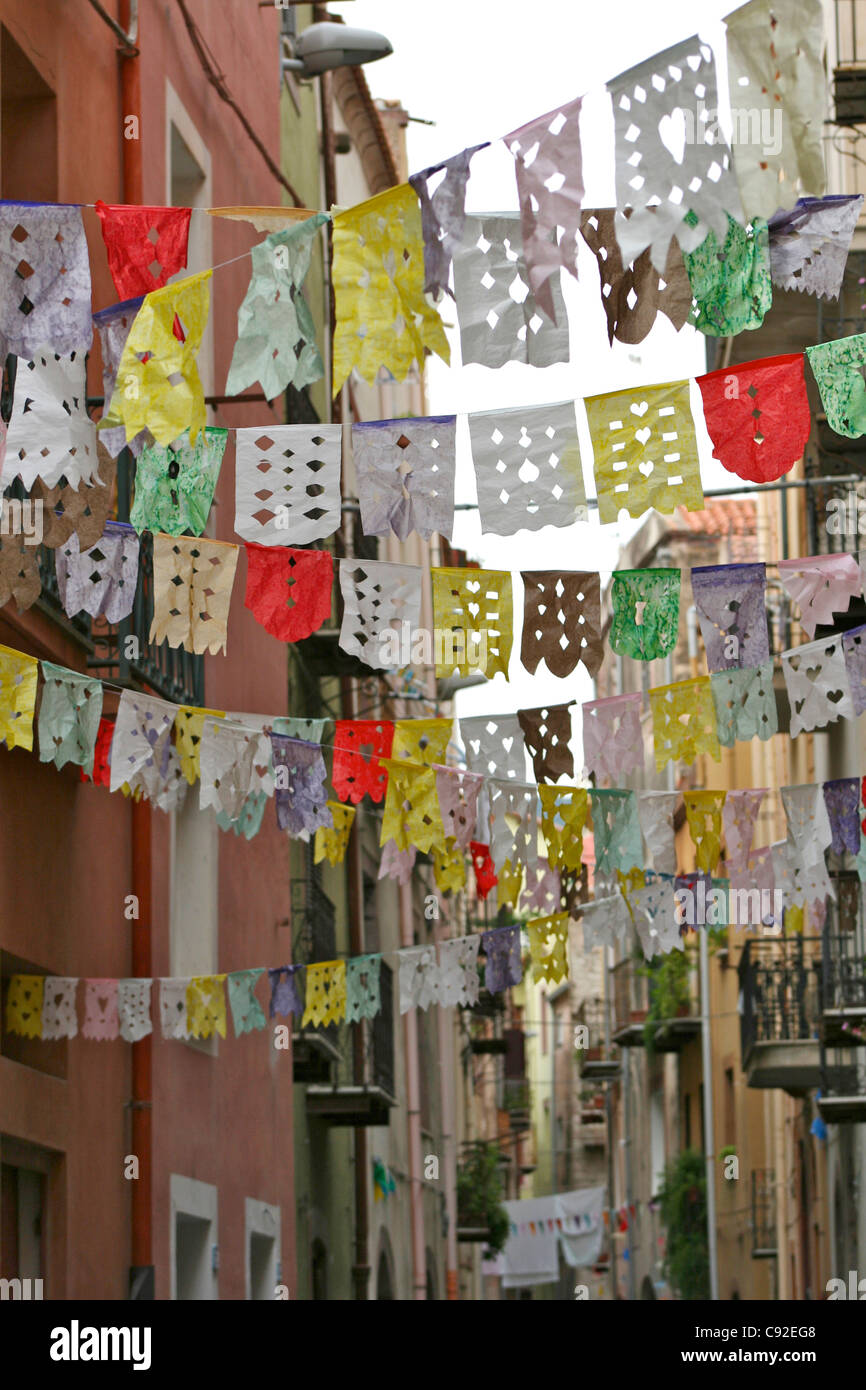Colourful plaster faced terraced houses line a narrow and steep street ...