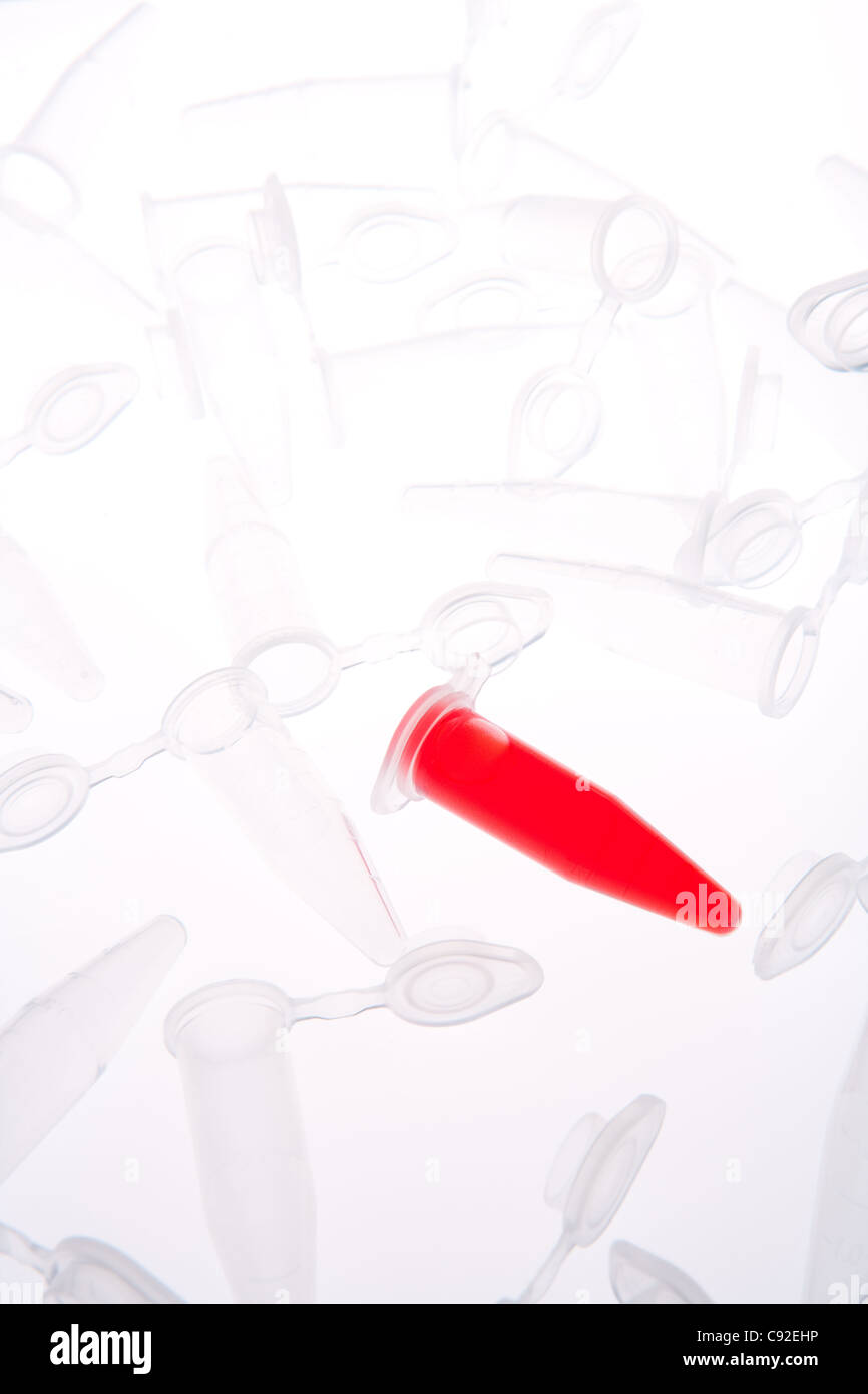 Red liquid filled test tube between empty test tubes Stock Photo - Alamy