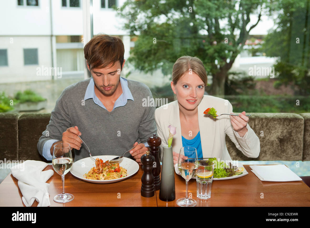 Couple eating together at restaurant Stock Photo - Alamy