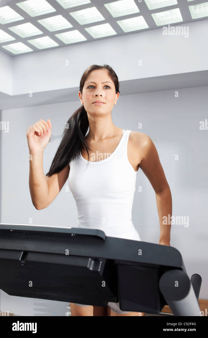 Woman exercising on treadmill Stock Photo - Alamy