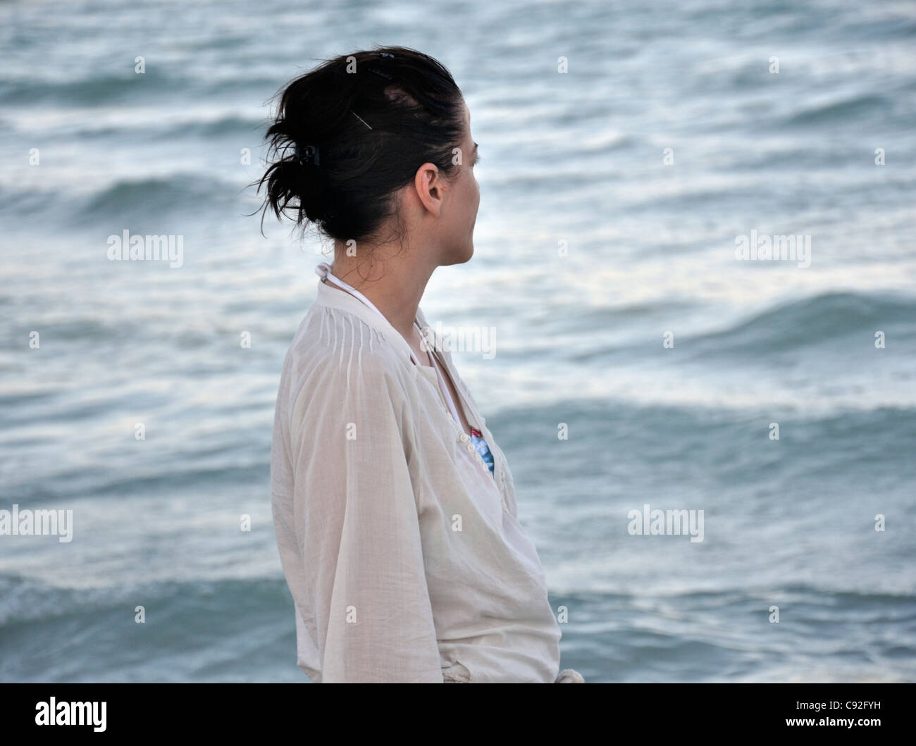 Young woman looking out to sea Stock Photo - Alamy
