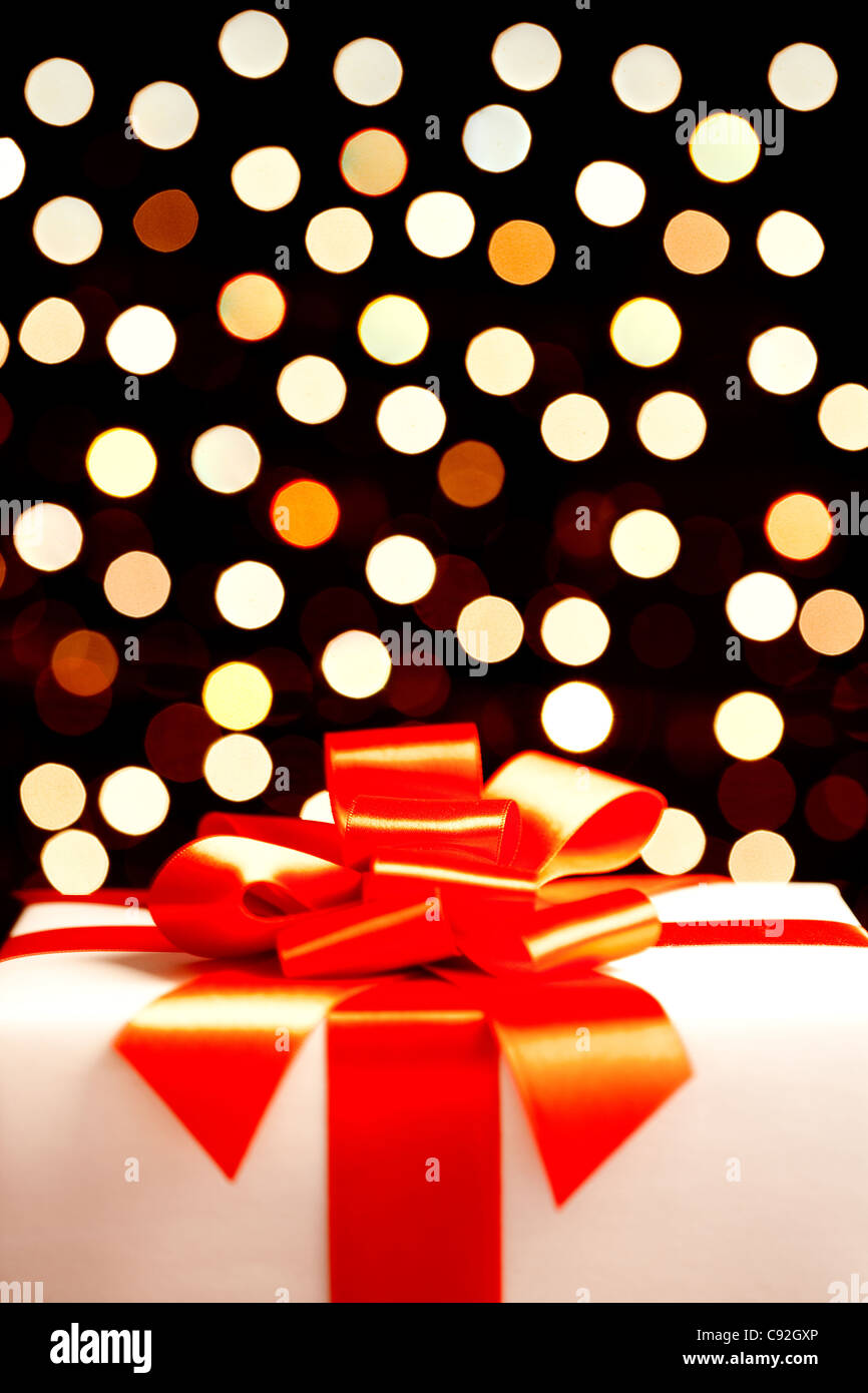 Gift box with abstract light pattern in the background Stock Photo - Alamy