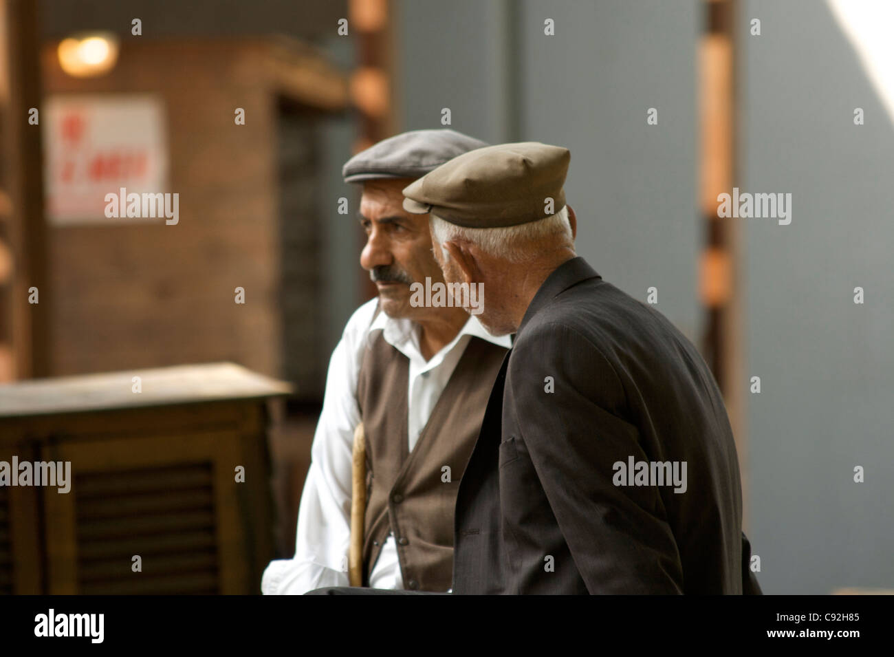 Two Turkish men in traditonal caps in conversation in Istanbul, Turkey ...