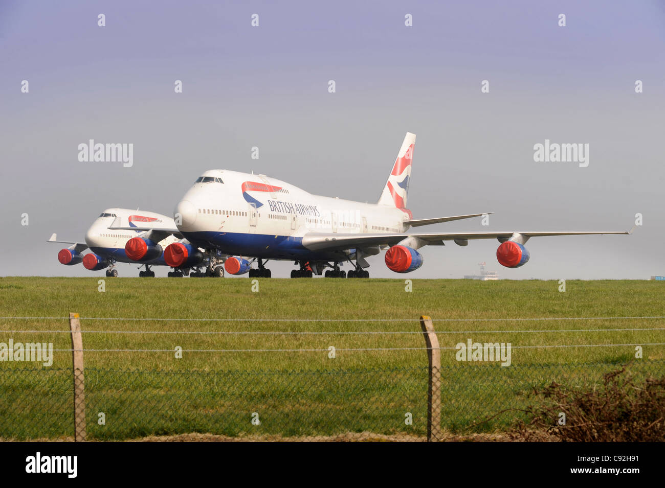 Two British Airways Boeing 747 passenger jets with engine covers parked ...