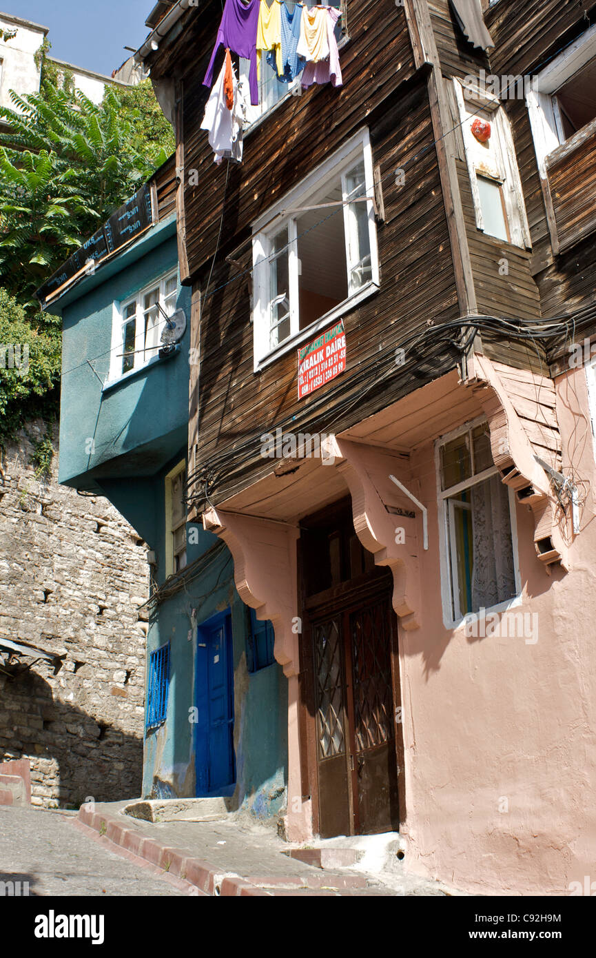 Traditional wooden Ottoman style of house leaning over with white ...