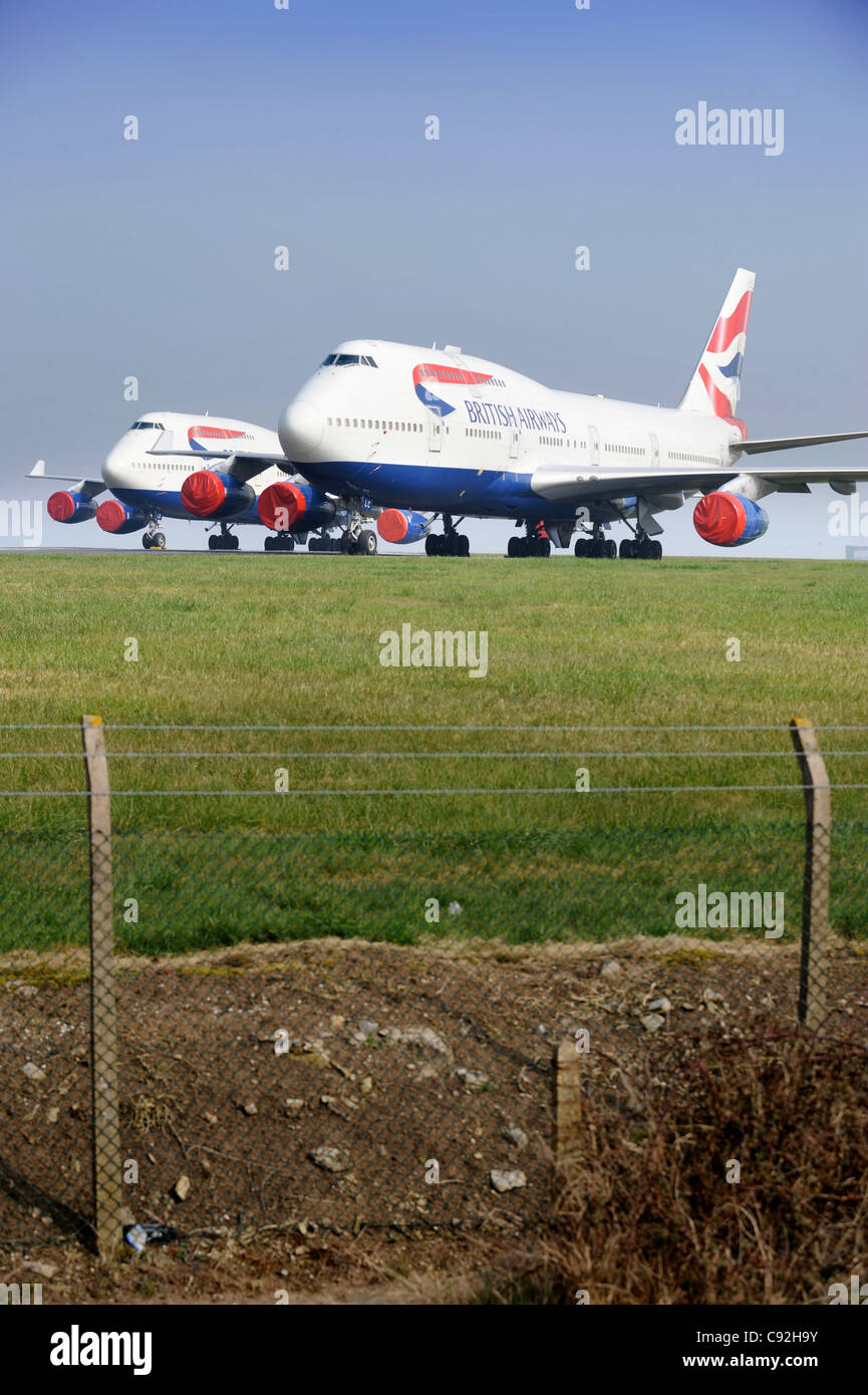 Two British Airways Boeing 747 passenger jets with engine covers parked ...