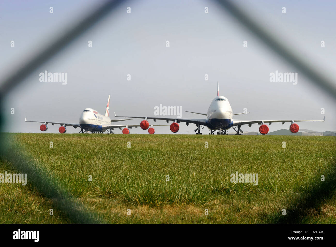Two British Airways Boeing 747 passenger jets with engine covers parked ...